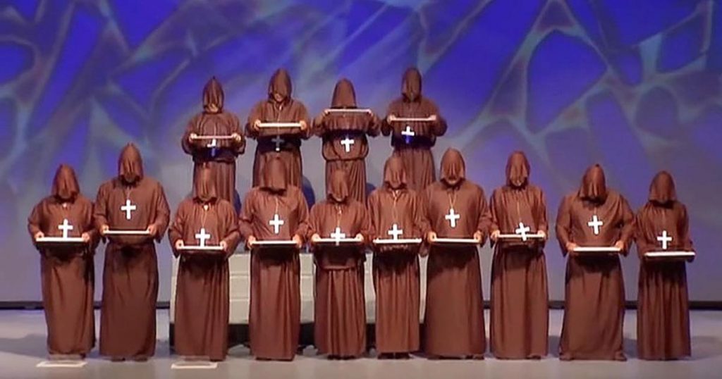 15 monks step onstage holding signs - deliver hilarious rendition of ...